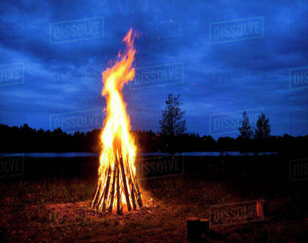 A tall bonfire with flames leaping up, at night - Royalty-free Stock ...