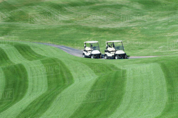 A golf course with mown fairways creating a pattern on an undulating ...