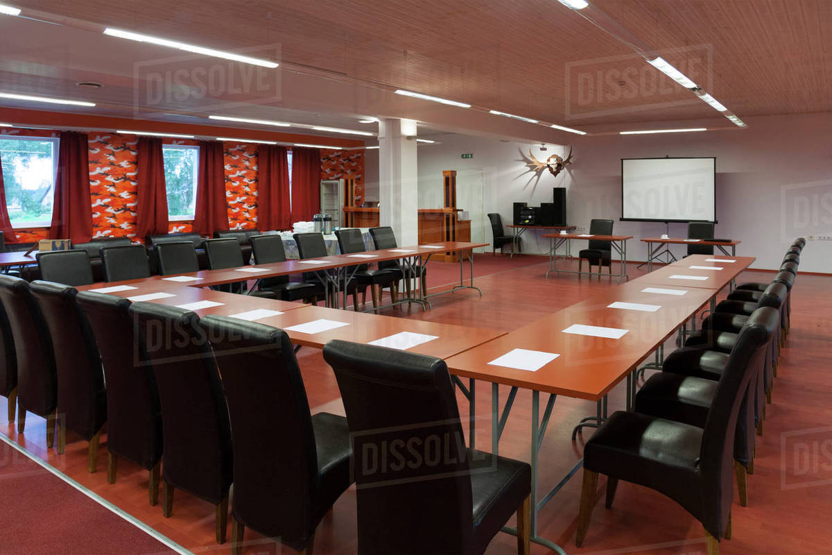 Tables and chairs set out for a conference or presentation, - Royalty ...