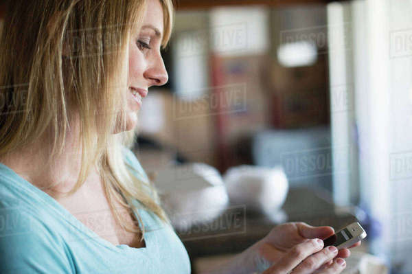 Caucasian woman using cell phone - Royalty-free Stock Photo | Dissolve