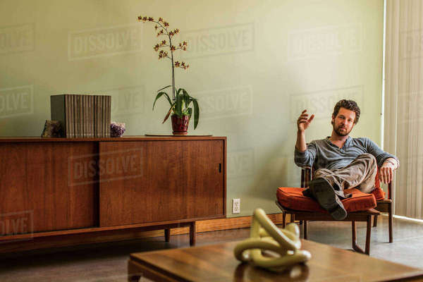 Caucasian man relaxing in living room - Royalty-free Stock Photo | Dissolve