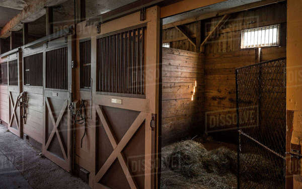 Empty stables in barn - Stock Photo - Dissolve