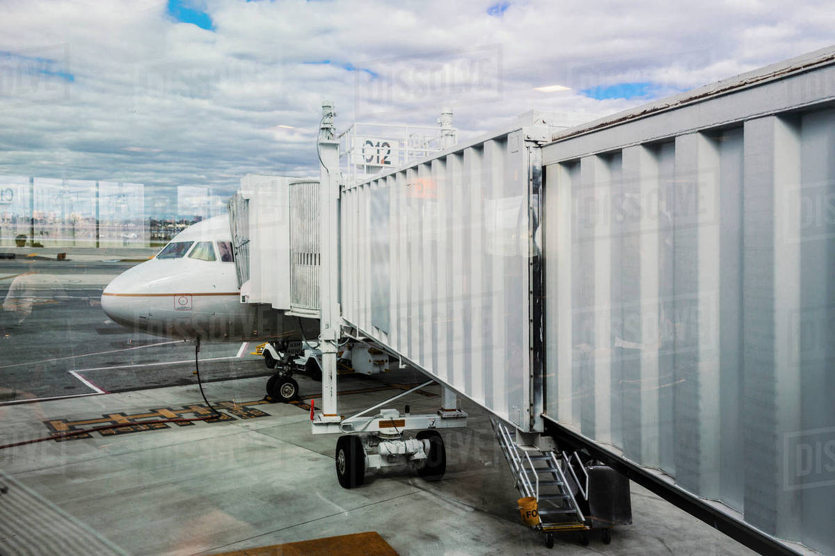 Walkway to airplane on runway - Stock Photo - Dissolve