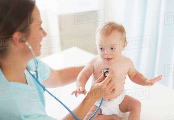 Caucasian doctor tending to baby girl with Down Syndrome - Royalty-free ...