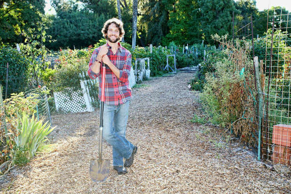 Caucasian man standing in garden - Royalty-free Stock Photo | Dissolve