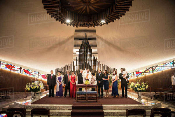 Family posing at wedding in church - Stock Photo - Dissolve