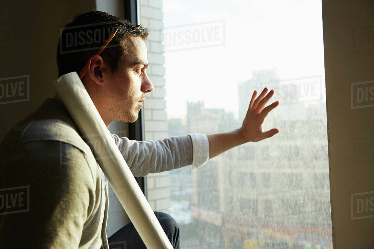 Caucasian architect looking out office window - Royalty-free Stock ...