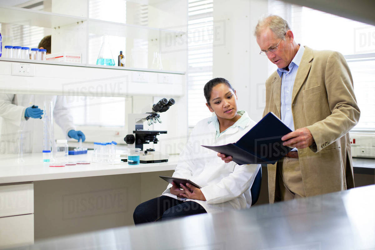 Businessman and scientist talking in laboratory - Stock Photo - Dissolve