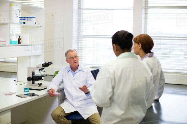 Scientists talking in laboratory - Royalty-free Stock Photo | Dissolve