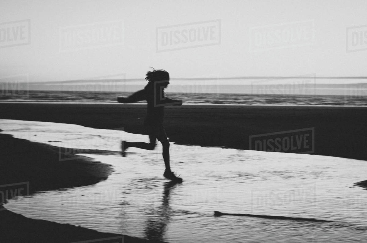 Girl running on beach - Stock Photo - Dissolve