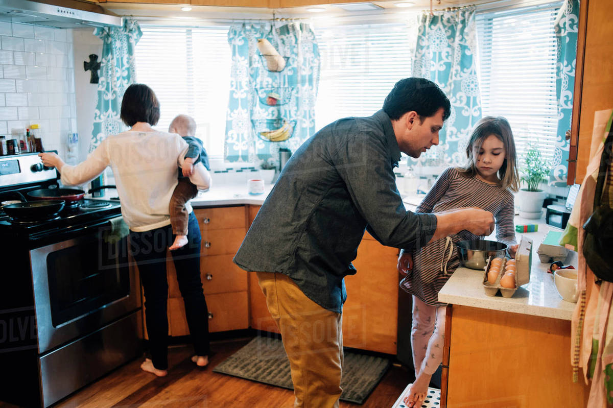 Parents cooking with children in kitchen - Stock Photo - Dissolve