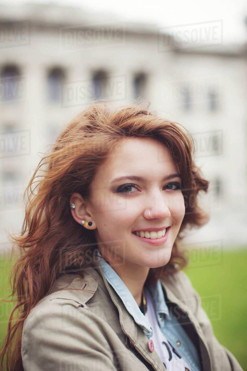 Caucasian student smiling on college campus - Stock Photo - Dissolve