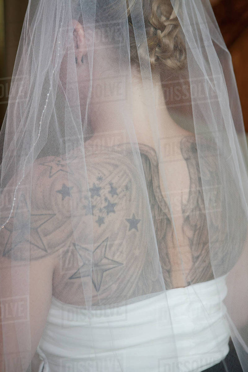 Rear view of Caucasian bride in veil with tattoos on back - Stock Photo ...