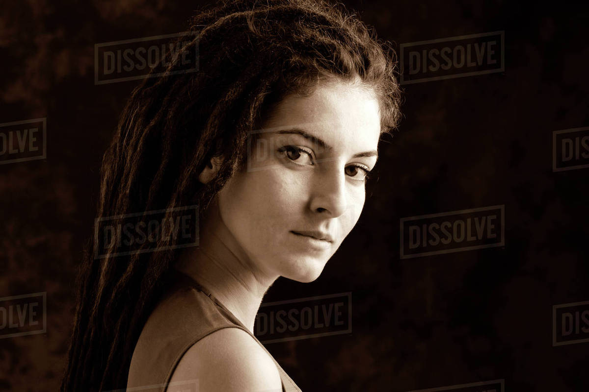 Close up of serious woman with dreadlocks - Stock Photo - Dissolve