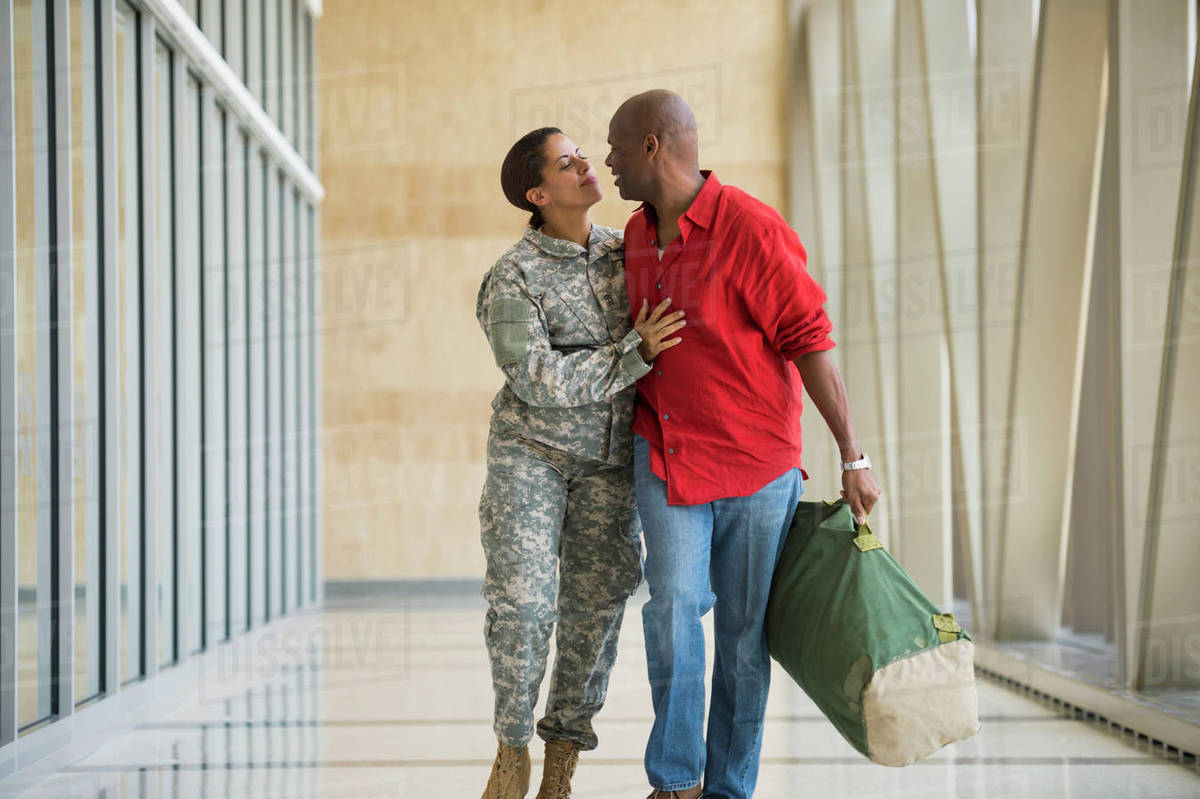 African American soldier talking to husband in airport - Royalty-free ...