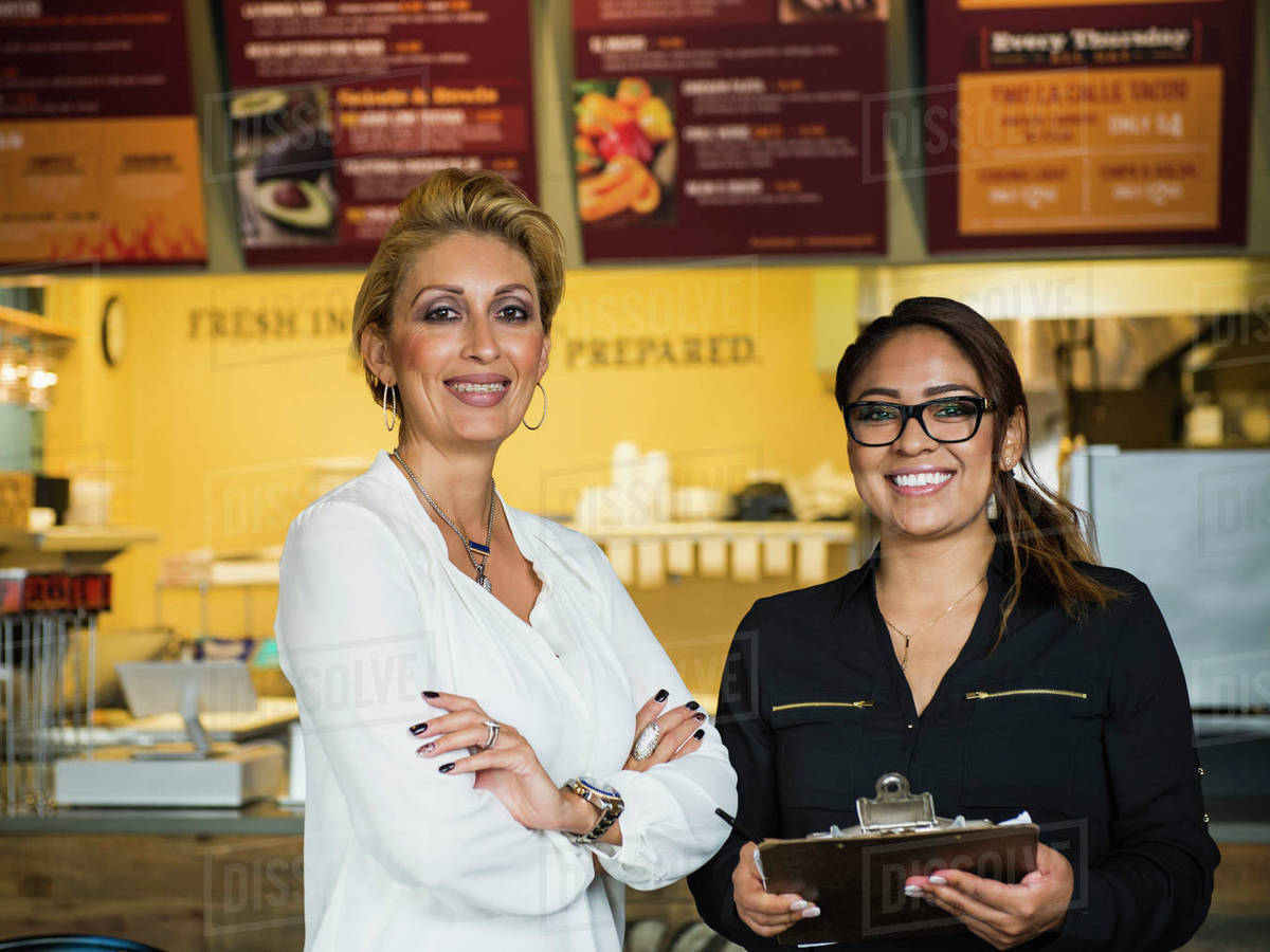Hispanic business owner and employee smiling in cafe - Stock Photo ...