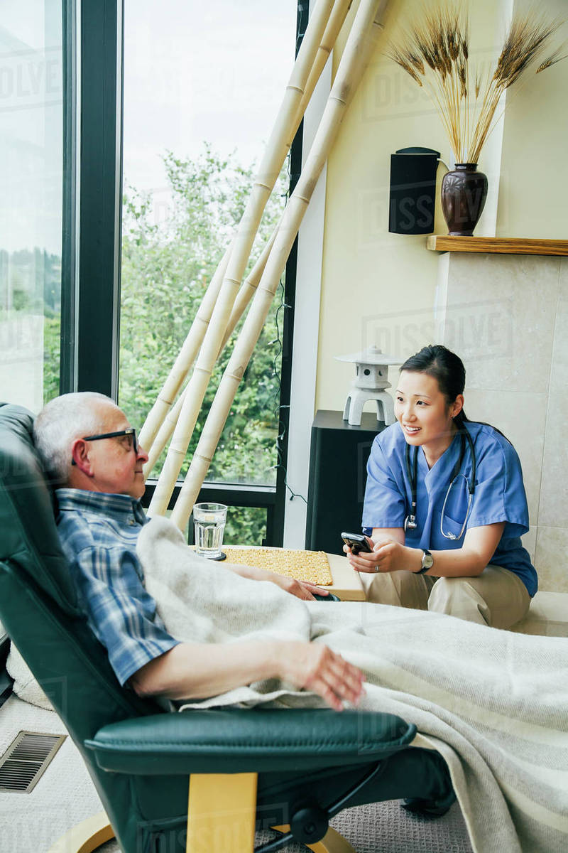 Nurse texting on cell phone near patient - Royalty-free Stock Photo ...