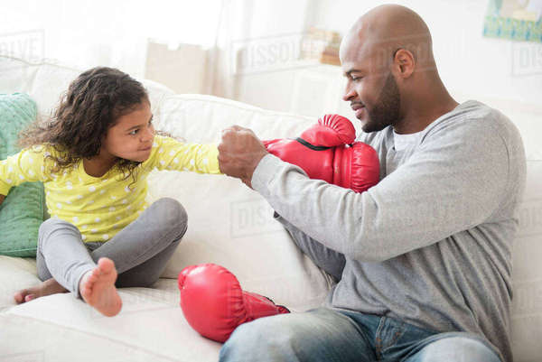 Father helping daughter with boxing gloves - Royalty-free Stock Photo ...