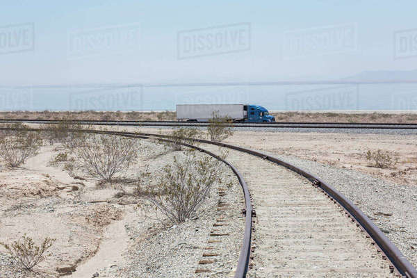 Semi-trick driving near railroad track - Royalty-free Stock Photo ...