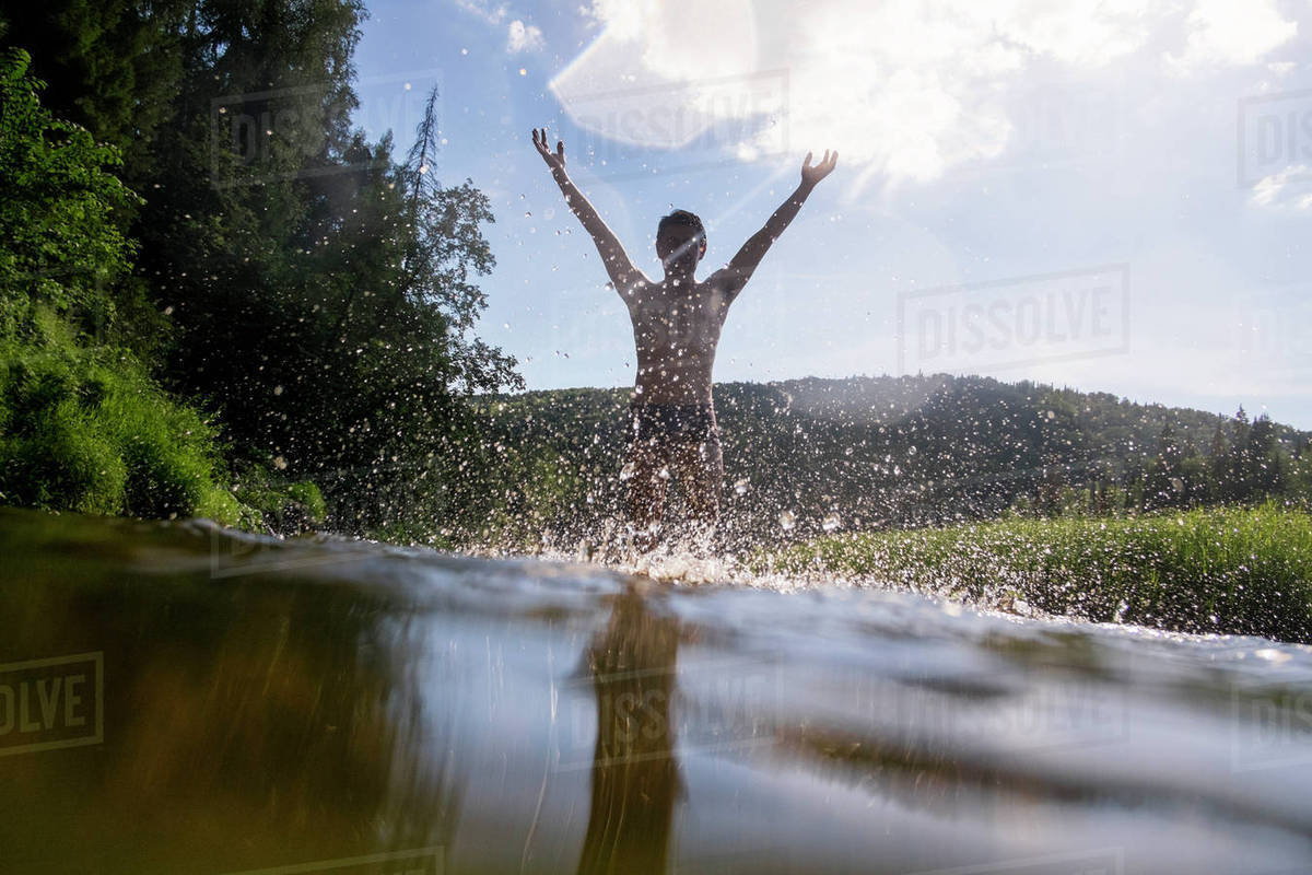 Mari man splashing in lake - Royalty-free Stock Photo | Dissolve