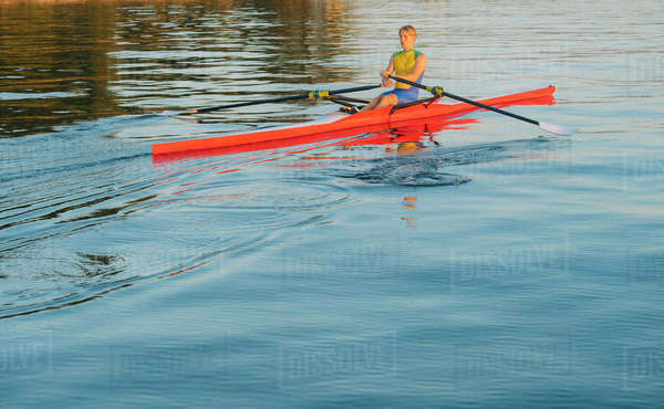 Caucasian man rowing on lake - Royalty-free Stock Photo | Dissolve