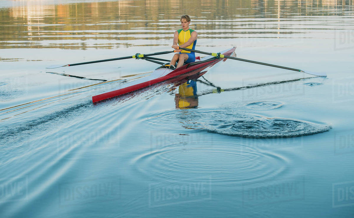 Caucasian man rowing on lake - Stock Photo - Dissolve