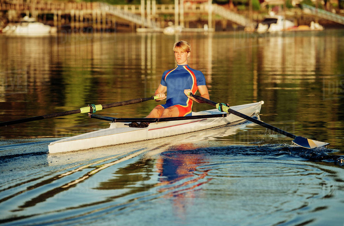 Caucasian man rowing on river - Royalty-free Stock Photo | Dissolve