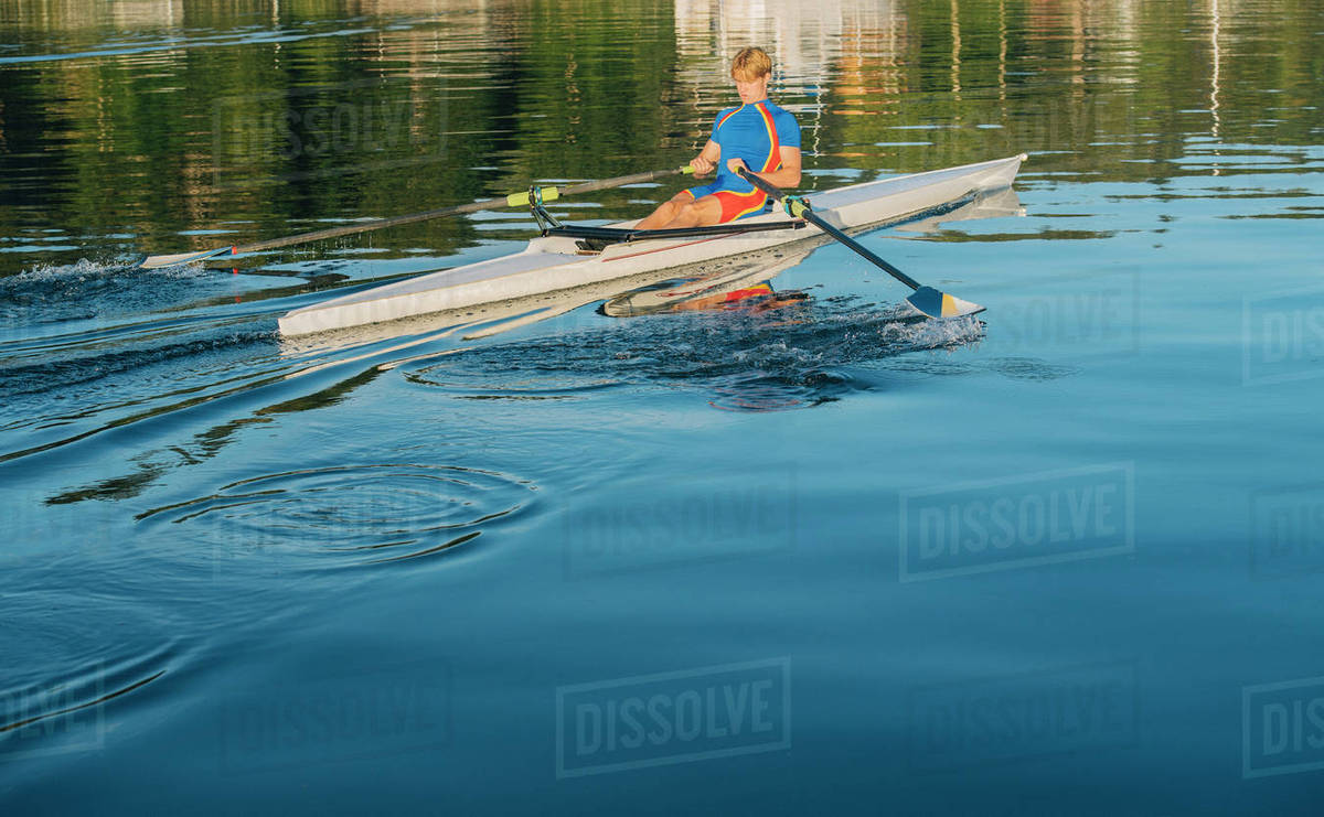 Caucasian man rowing on river - Royalty-free Stock Photo | Dissolve