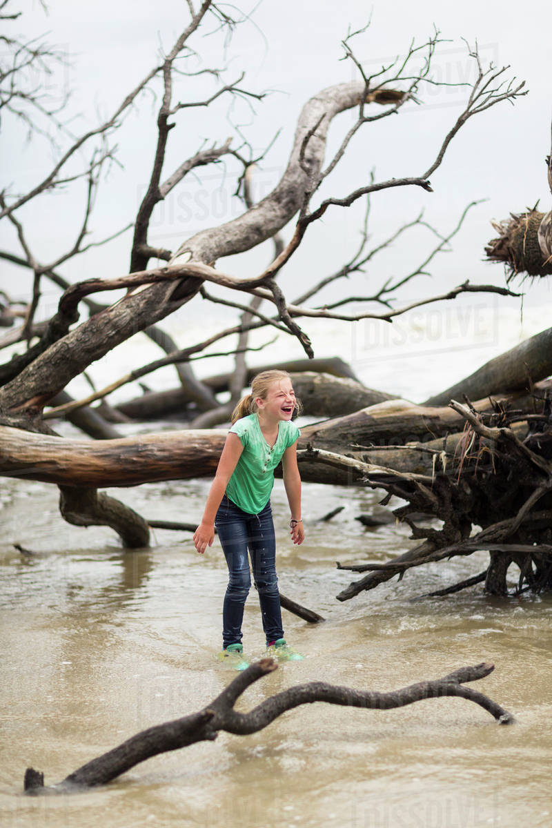 Caucasian girl playing in river near driftwood - Royalty-free Stock ...