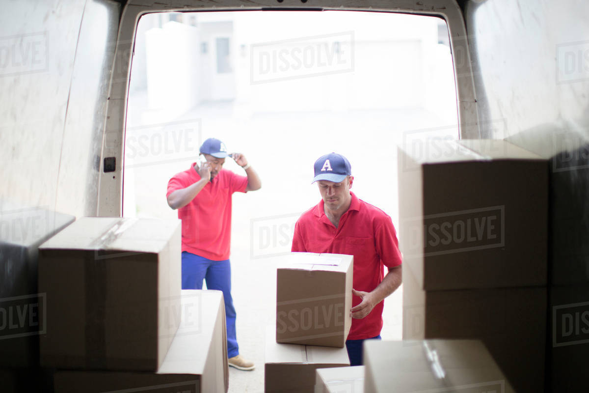 Delivery men unloading packages in van - Royalty-free Stock Photo ...