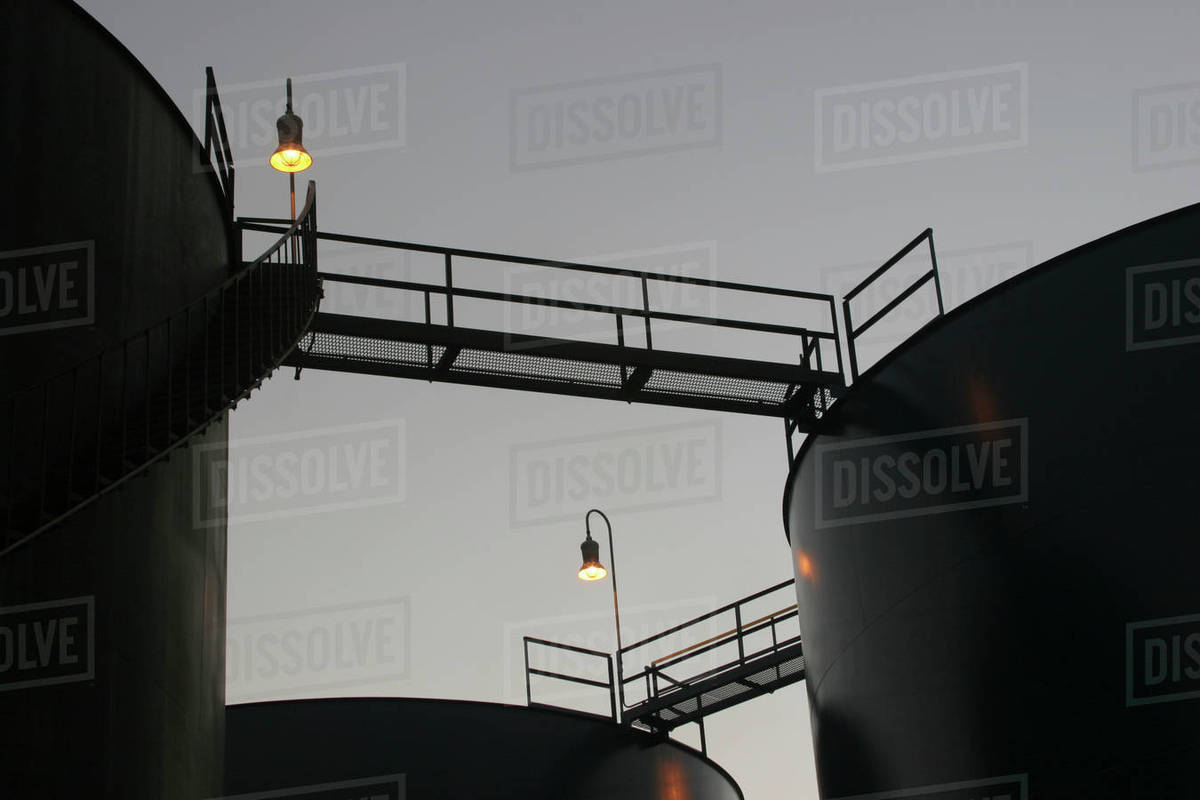 Walkway between storage tanks - Royalty-free Stock Photo | Dissolve