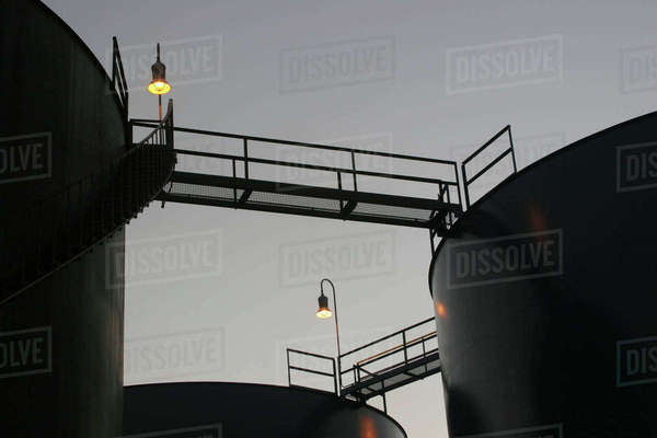 Walkway between storage tanks - Royalty-free Stock Photo | Dissolve