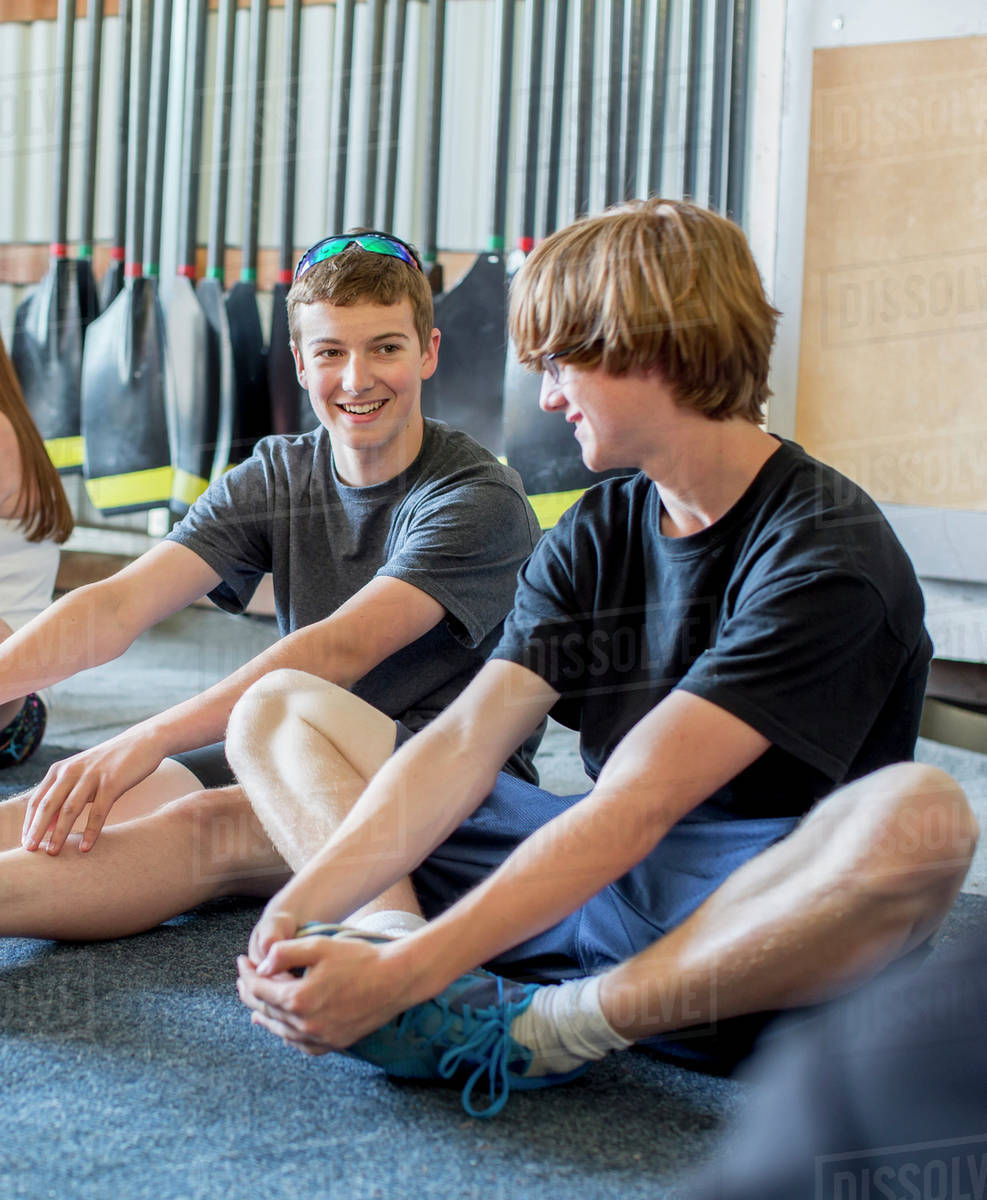 Caucasian boys stretching in boathouse - Royalty-free Stock Photo ...