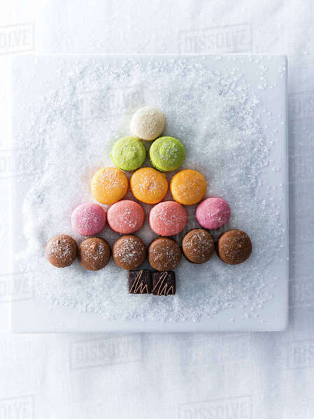 Macaroons and chocolate in shape of tree on plate with sugar - Stock ...