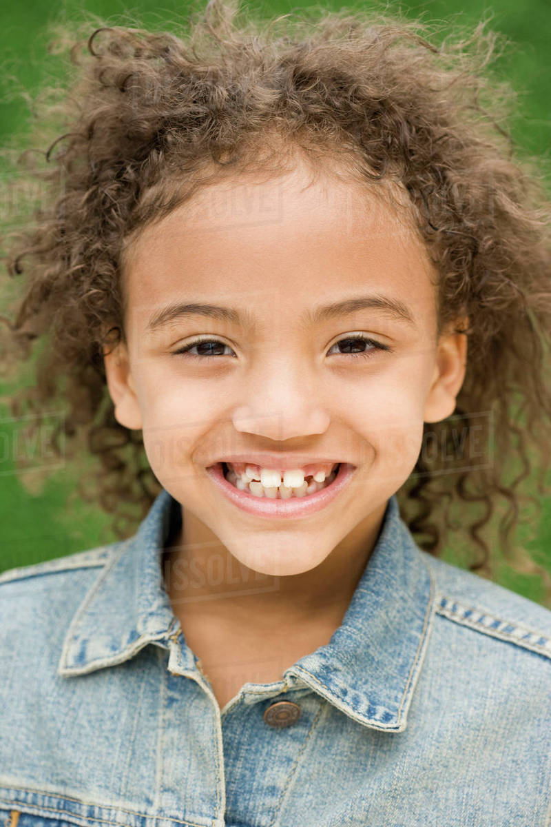 Close up of Mixed Race girl smiling - Stock Photo - Dissolve