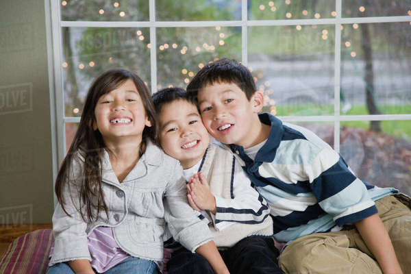 Mixed Race siblings hugging - Royalty-free Stock Photo | Dissolve