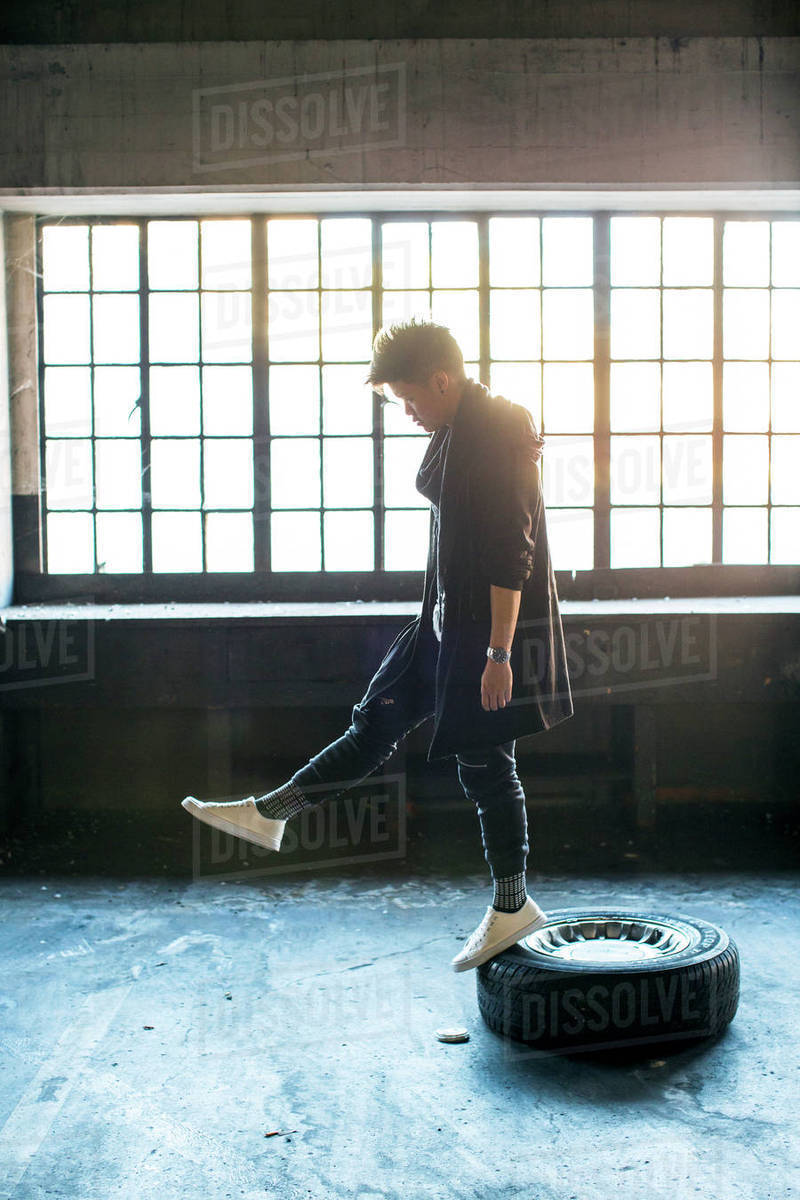 Man standing on wheel - Royalty-free Stock Photo | Dissolve