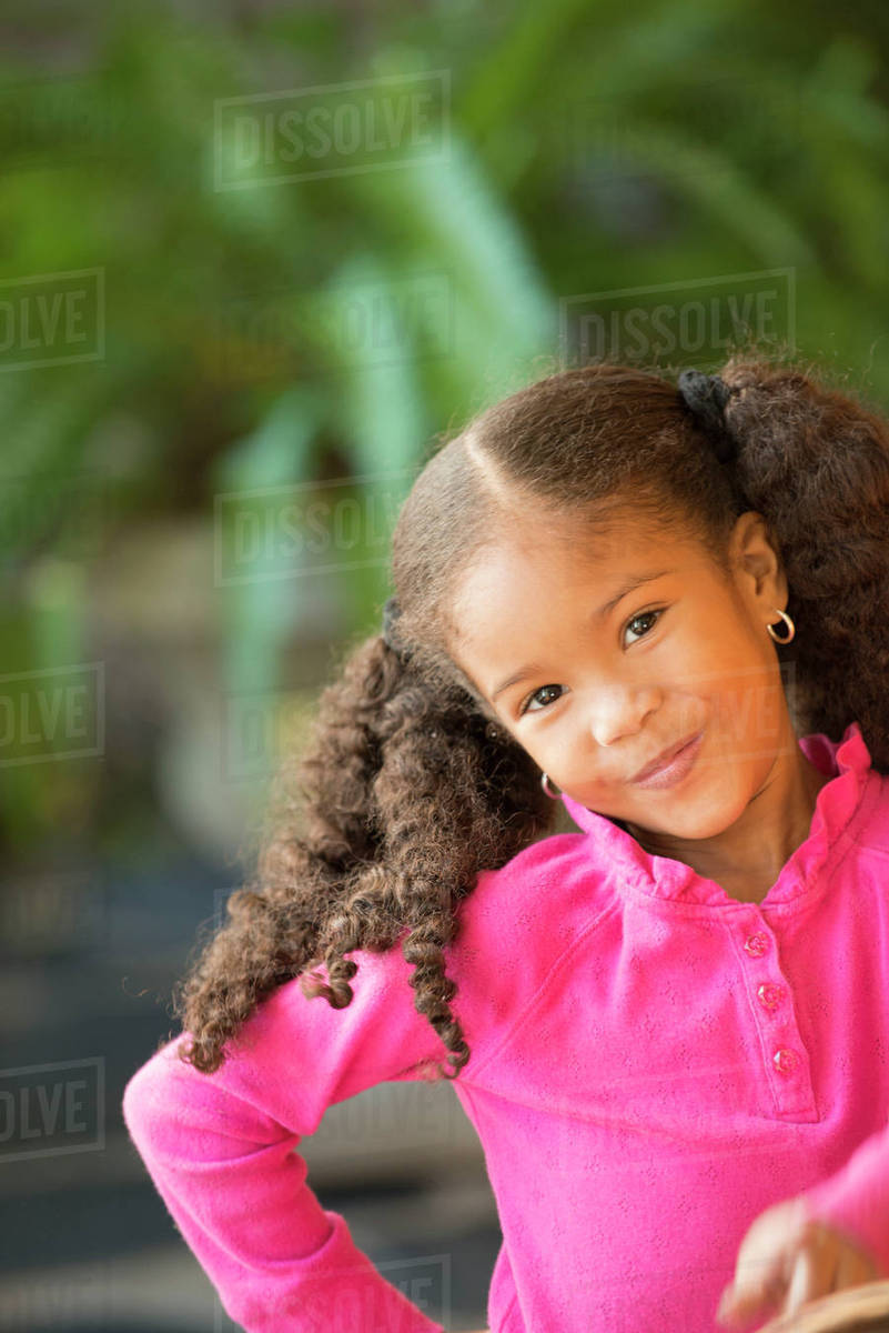 Portrait of smiling Mixed Race girl - Royalty-free Stock Photo | Dissolve