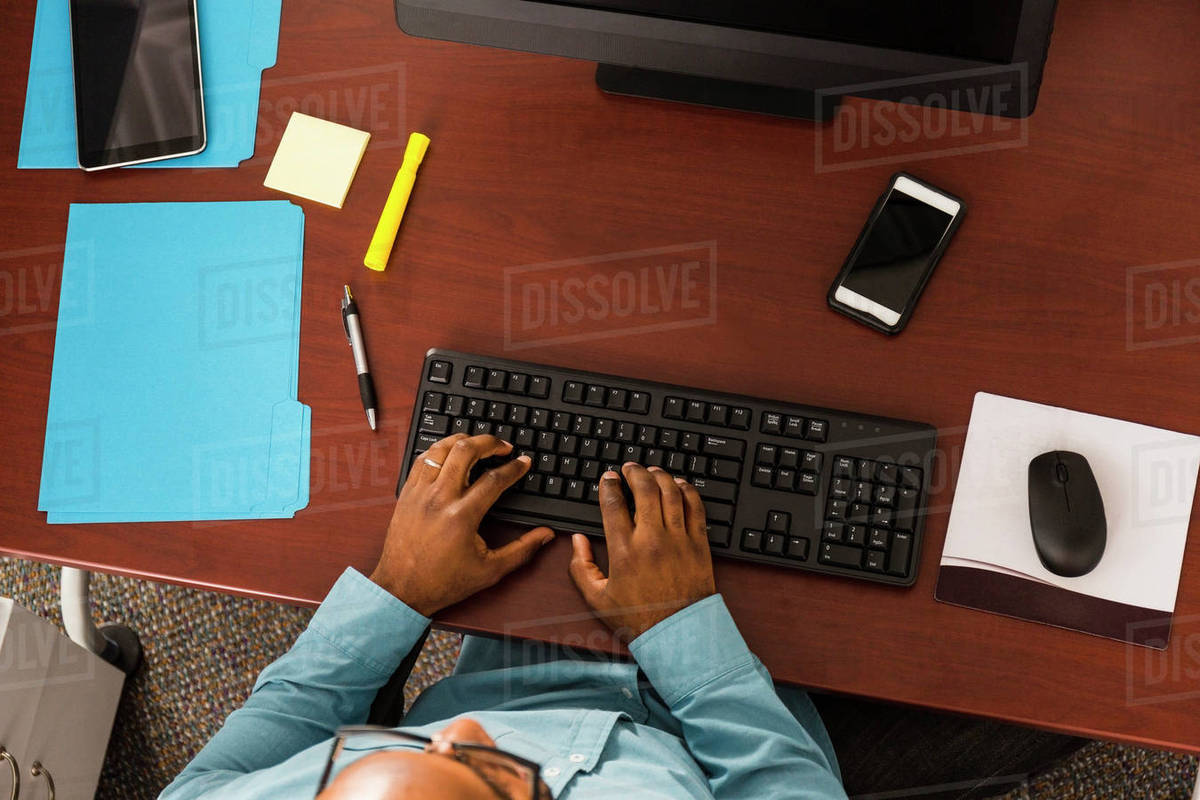 African American man typing on computer keyboard in office - Royalty ...