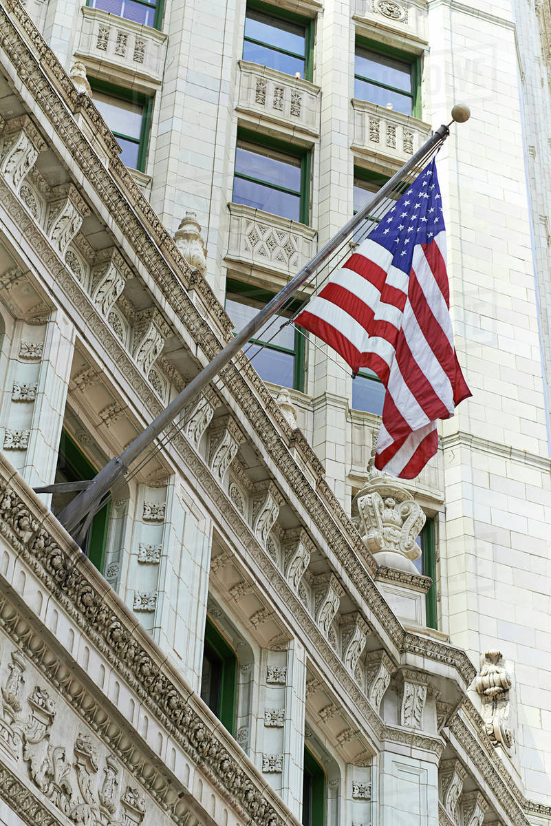 American flag hanging from ornate building - Royalty-free Stock Photo ...
