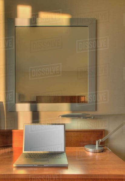 Laptop on desk in hotel room - Royalty-free Stock Photo | Dissolve