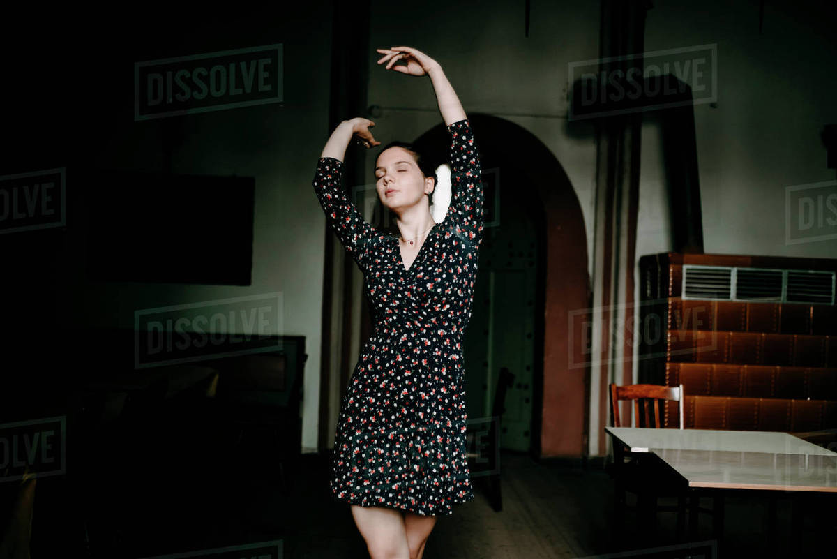 Caucasian woman dancing in livingroom - Royalty-free Stock Photo | Dissolve