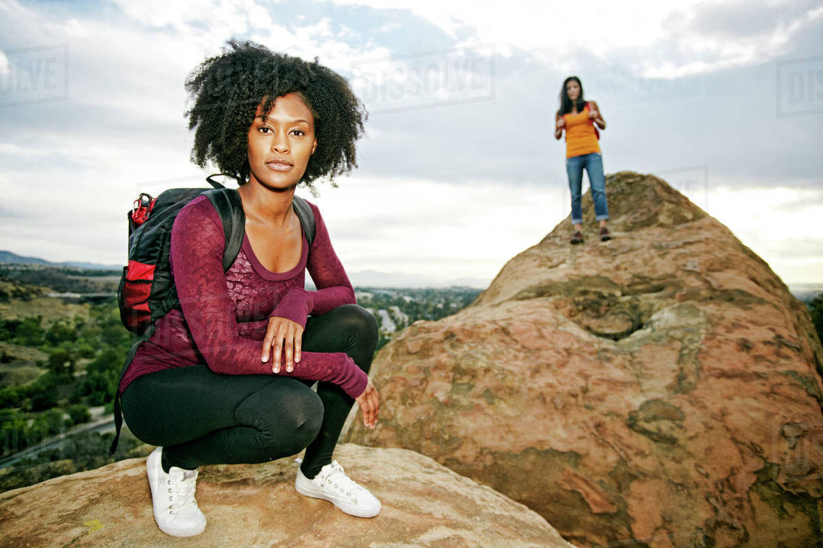 Portrait of serious women posing on rock formation - Stock Photo - Dissolve
