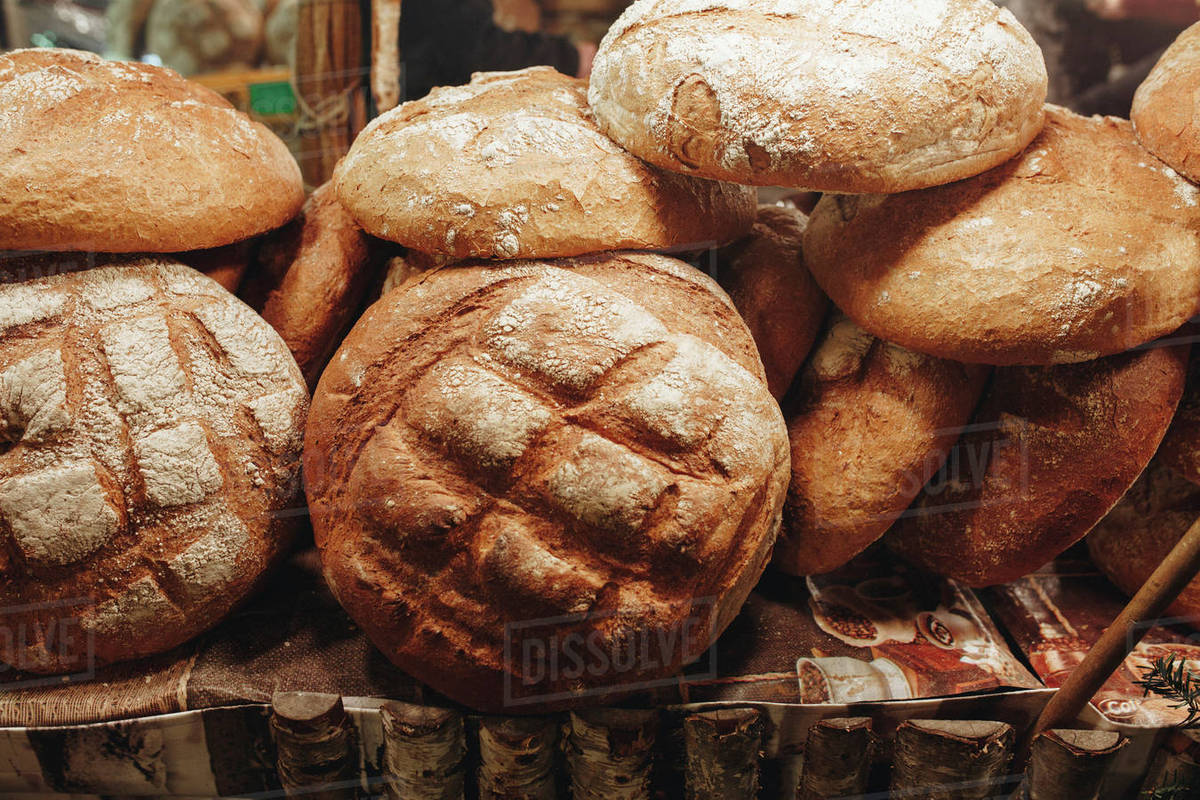 Pile of loaves of bread on table - Stock Photo - Dissolve