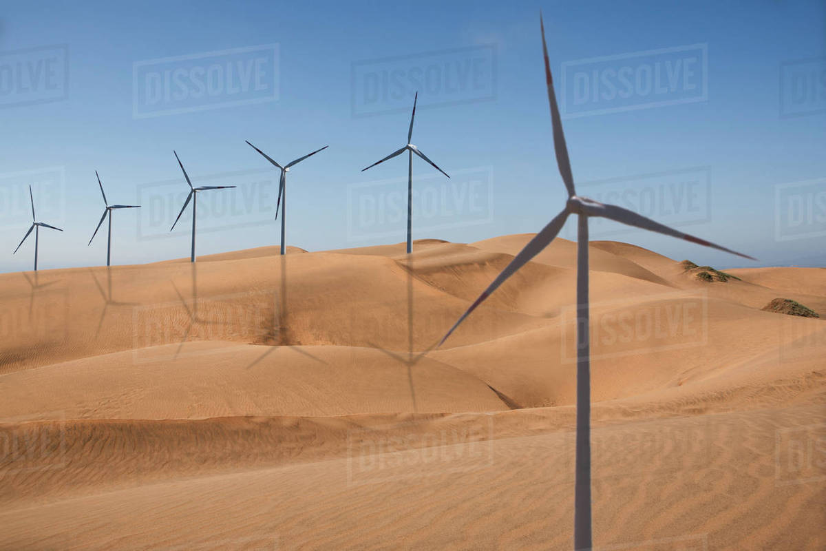 Row of wind turbines in desert - Royalty-free Stock Photo | Dissolve