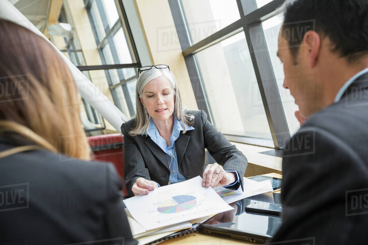 Business people examining chart in meeting - Royalty-free Stock Photo ...