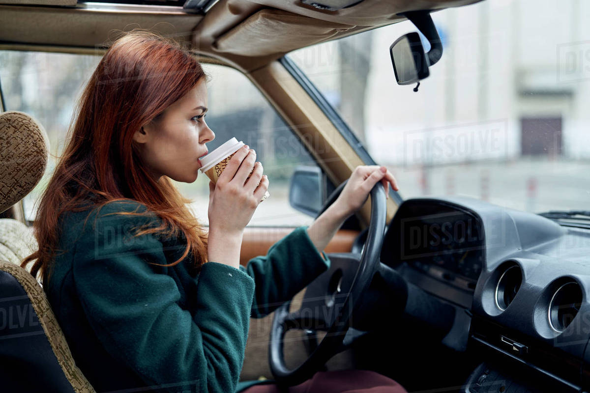 Caucasian woman driving car and drinking coffee - Royalty-free Stock ...