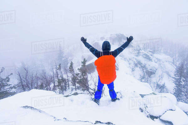 Caucasian hiker waving on snow covered mountain - Royalty-free Stock ...
