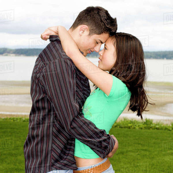 Teenage couple hugging outdoors - Royalty-free Stock Photo | Dissolve