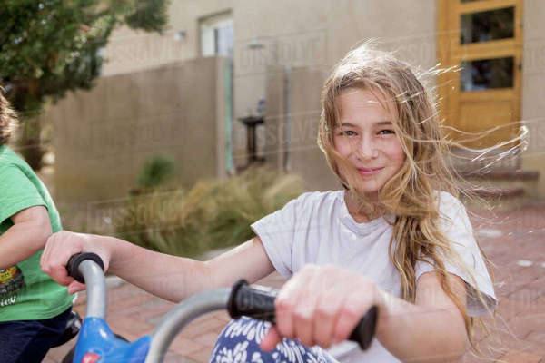 Wind blowing hair of Caucasian girl on bicycle - Royalty-free Stock ...